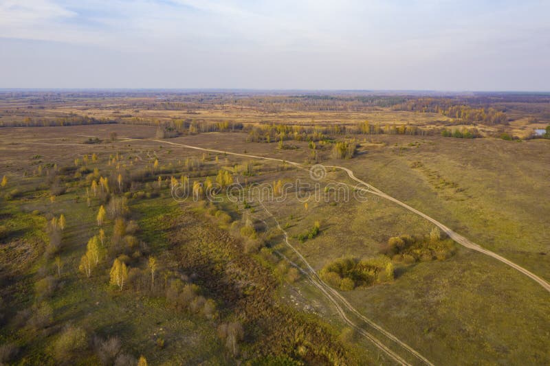 A Dirt Road Runs through a Field. Stock Photo - Image of landscape ...