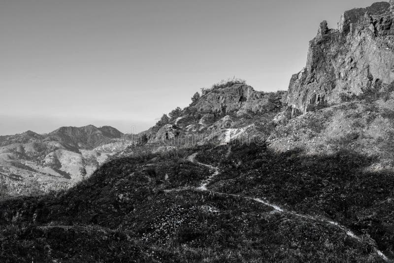 Dirt Road in Shadow of Rock Mountain Black and White Stock Image ...