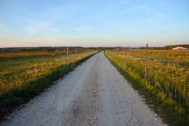 A Dirt Road between Two Private Chain Link Fences and Agricultural ...