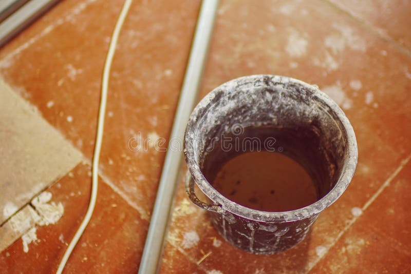 Dirty Black Plastic Bucket with Drips on Brown Floor Stock Image ...