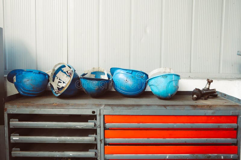 Dirty Blue Worker Helmets on Top of an Old, Rusty and Dirty Workbench ...