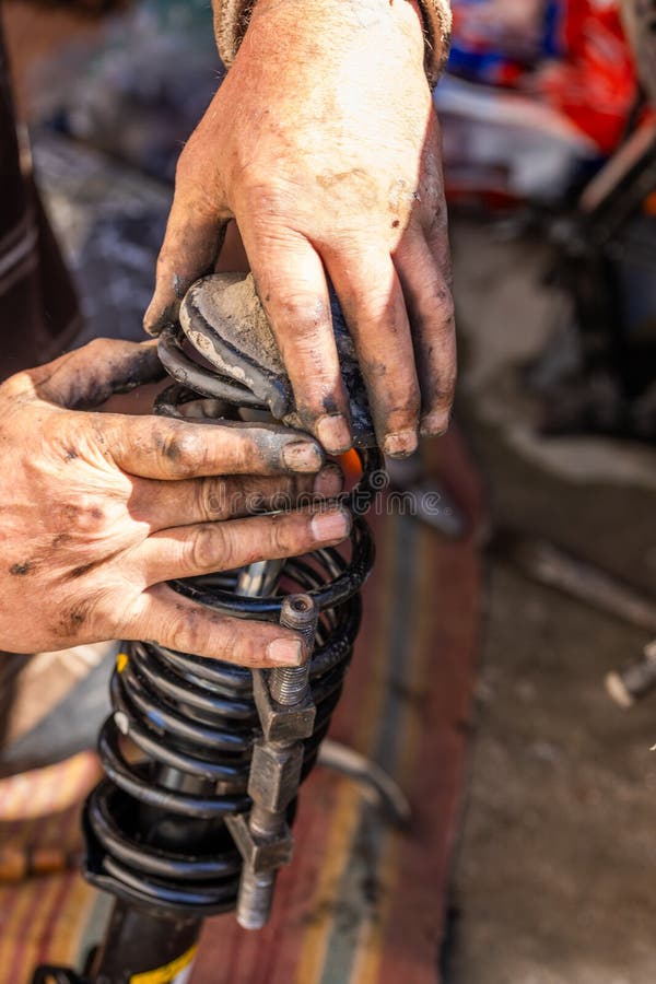 The Calloused Hands of a Mechanic Assembling Compressed Coil Spring ...