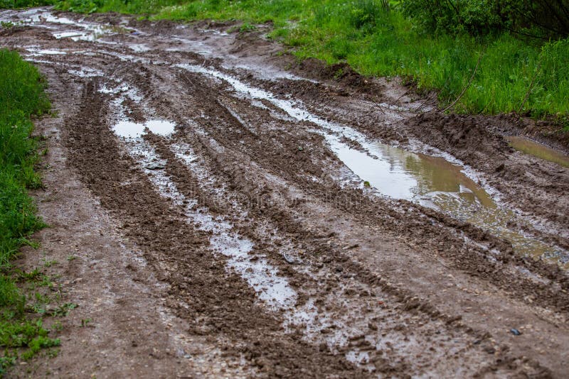 Dirty Clay Mud Road Zig-zag with Puddles and Tire Tracks - Closeup with ...