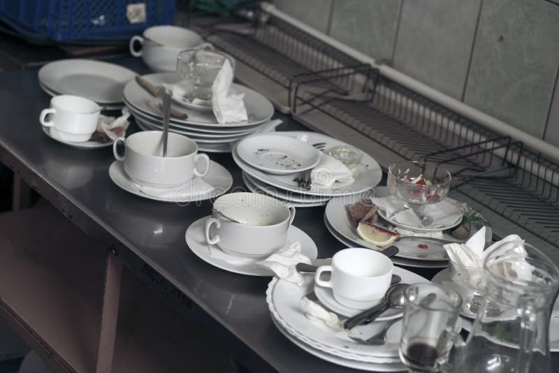 Dirty Cups and Plates with Leftovers and Silverware Placed on Metal ...
