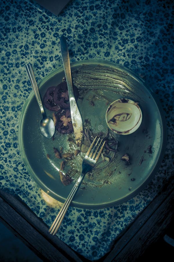 Dirty Dishes with Fork and Knife on a Green Plate Stock Photo - Image ...
