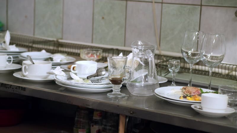 Dirty Dishware on Metal Table. Dirty Cups and Plates with Leftovers and ...