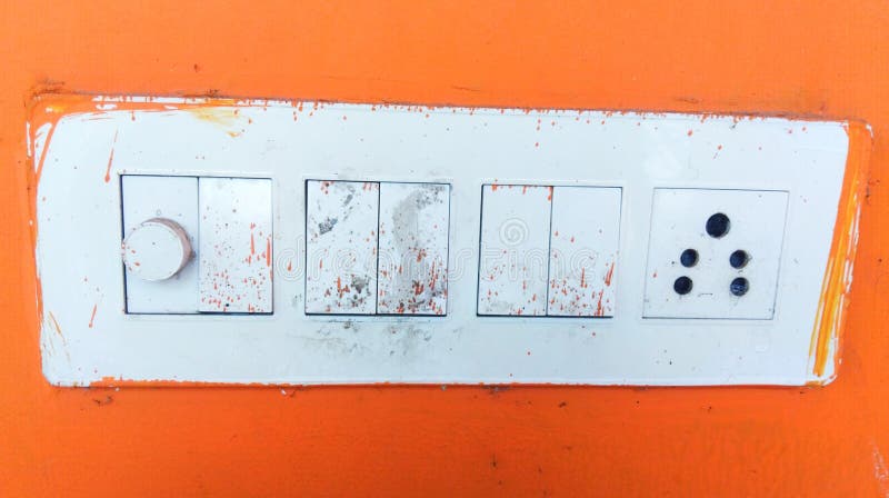 Dirty Electrical Switchboard with Paint Splatters on an Orange Wall ...