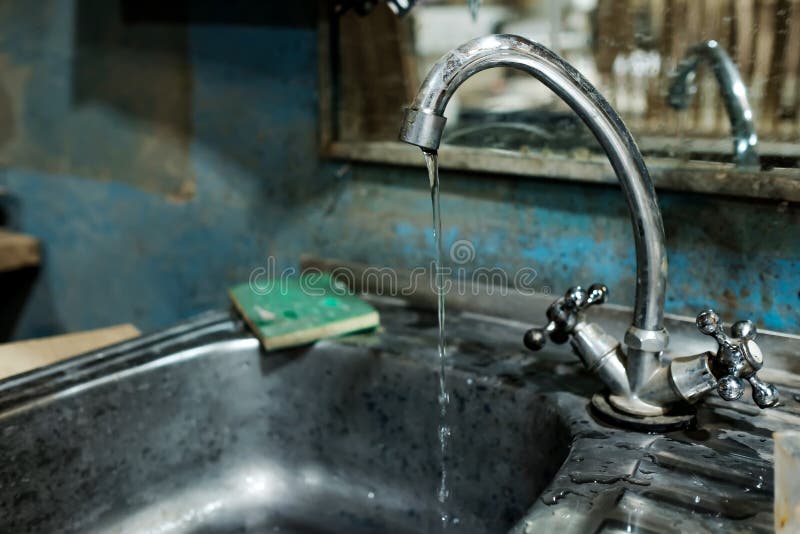 Dirty Little Wash Basin for Hands. Rusty Water Flows from the Tap Stock ...