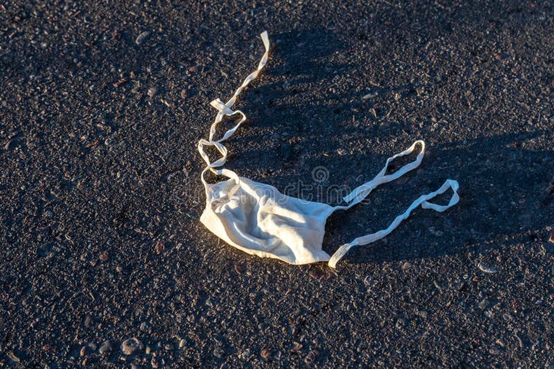 Dirty Mask Lying on the Ground - Sunset - Covid - 19 Stock Photo ...