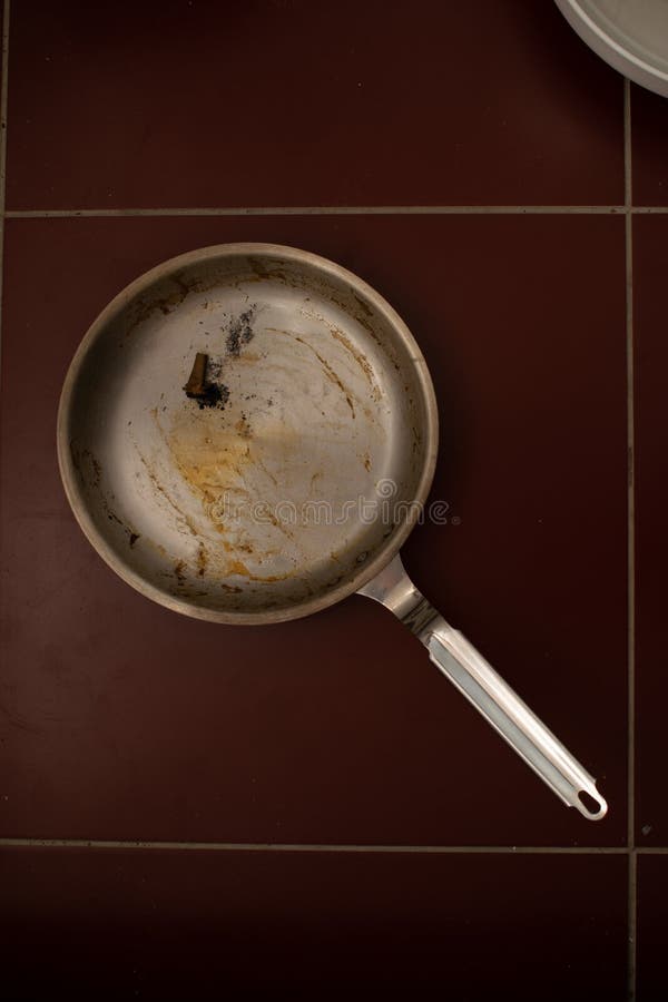 Dirty Pan with Extinguished Cigarette Editorial Image - Image of ...