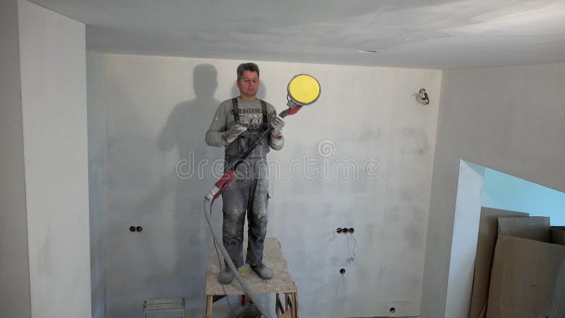 Dirty Plasterer Man Polish Ceiling with Sanding Grinder Machine Stock ...
