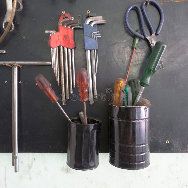 Dirty Set of Hand Tools on a Wooden Panel and Part in the Cans Stock ...