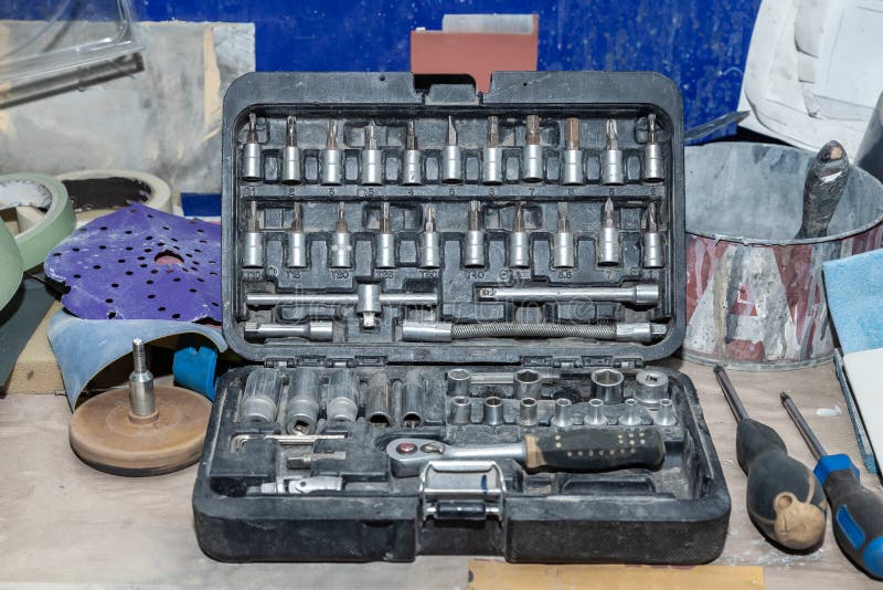 Dirty Set of Tools in a Box with Wrenches and Various Attachments for ...