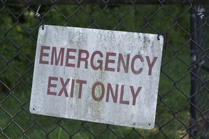 Emergency Exit Sign Weathered and Dirty on a Chain Link Fence Stock ...