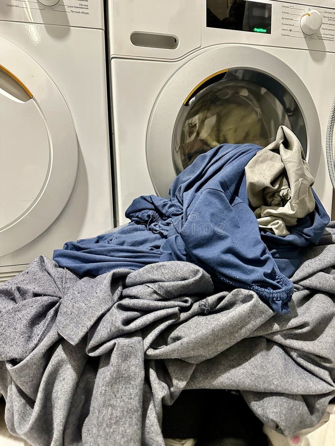 Dirty Things Against the Background of a Washing Machine. Bed Linen is ...