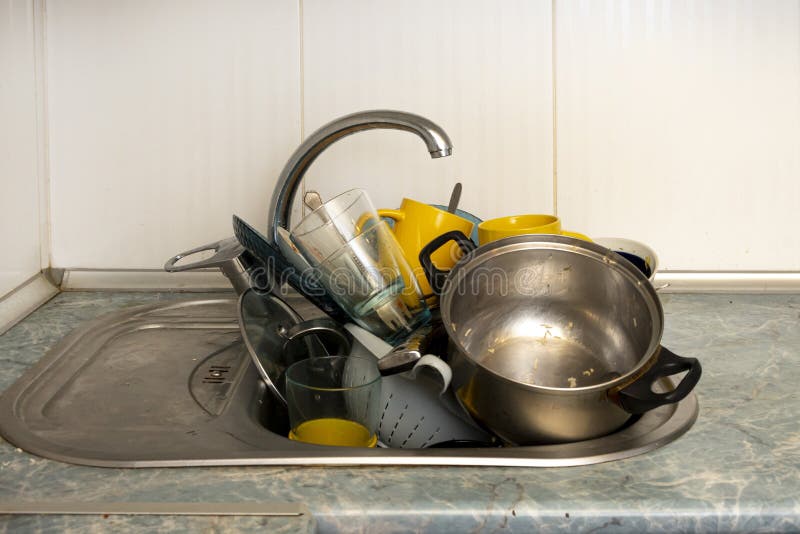 Dirty and Unwashed Dishes are Stacked in the Kitchen Sink. a Mountain ...