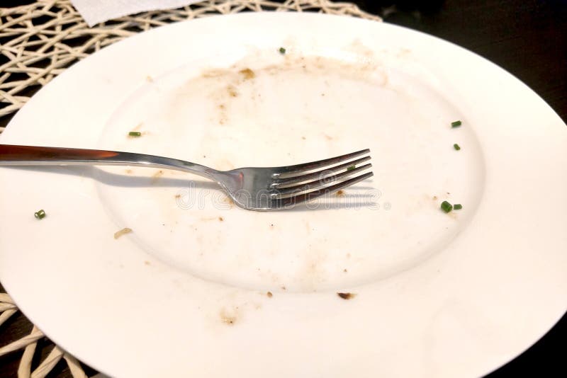 A Dirty White Plate with a Fork after Eating. Stock Image - Image of ...