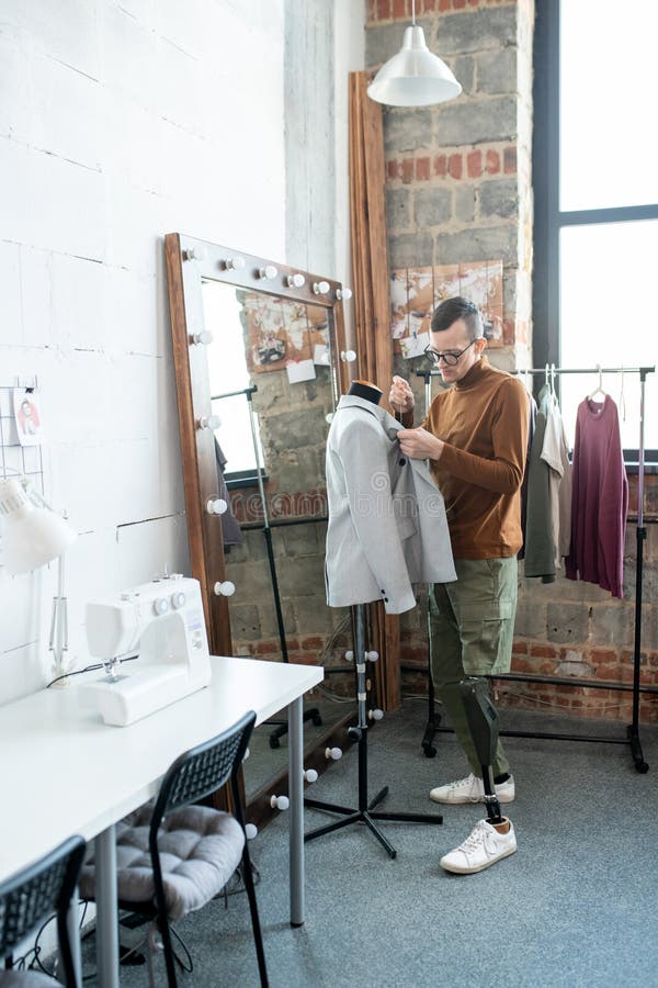 Disable Man with Leg Prosthesis Working Over New Jacket in Workshop ...
