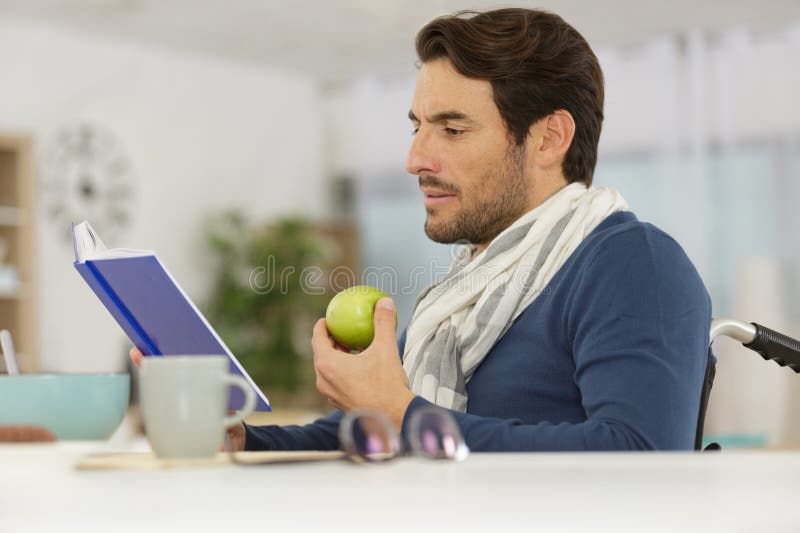 Disable Man Reading Book while Eating Apple Stock Photo - Image of ...