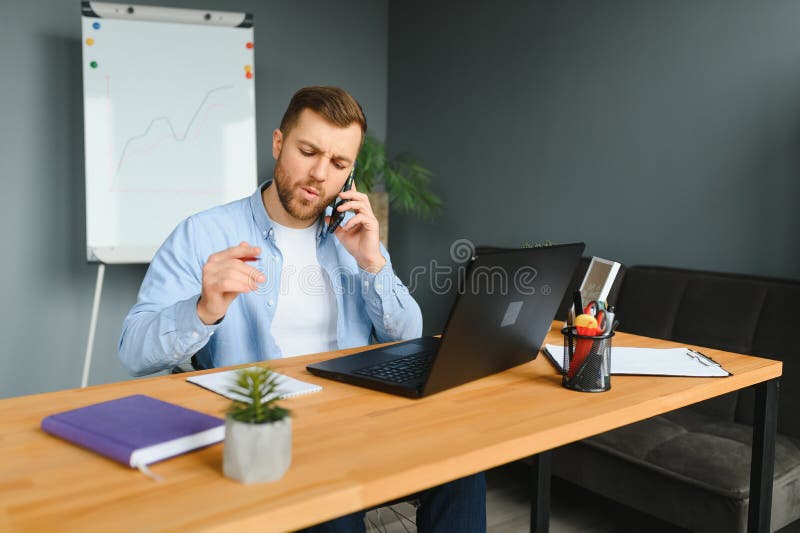 Disabled Businessman Sitting in Wheelchair Using Computer at Workplace ...