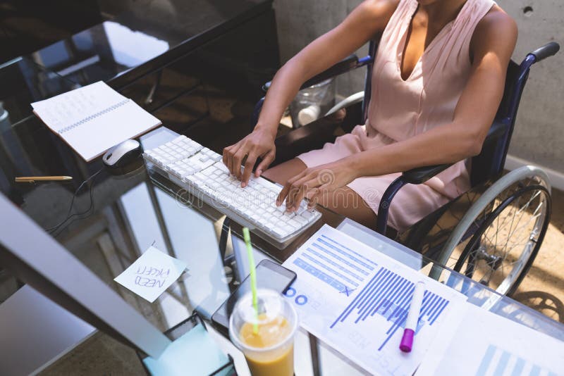 Disabled Businesswoman Working on Computer at Desk in the Office Stock ...