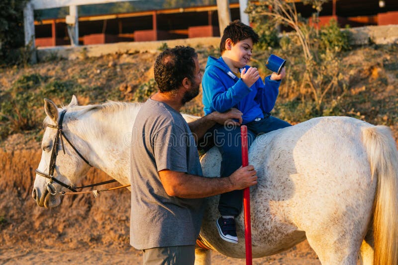 Disabled Child Doing Mobility Exercise during an Equine Therapy Session ...