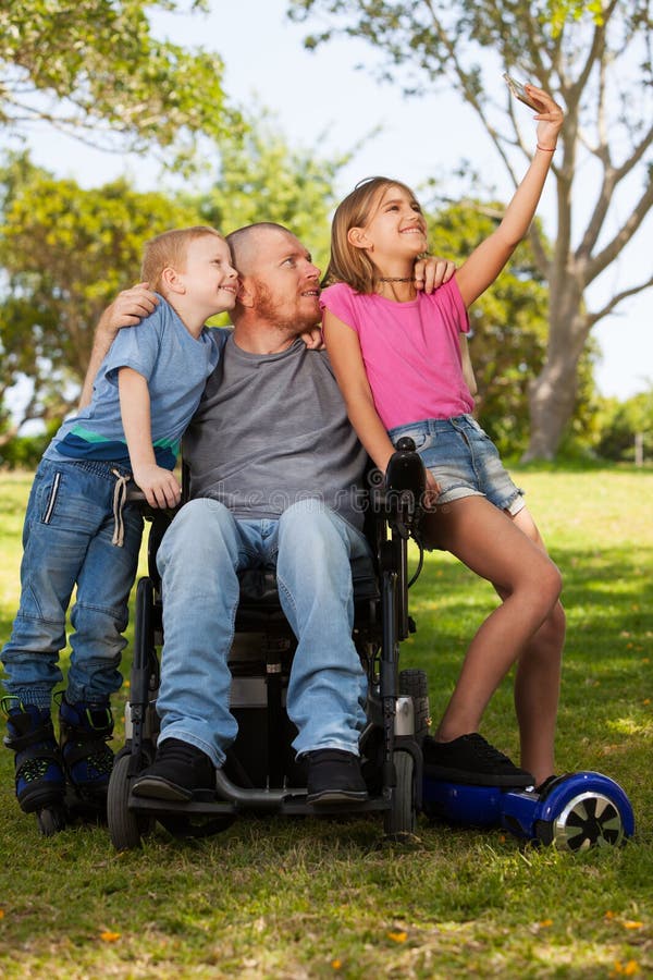 Disabled Father on the Wheelchair. Stock Photo - Image of park ...