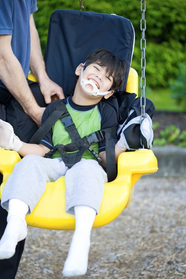 Disabled Five Year Old Boy in Handicap Swing Stock Photo - Image of ...