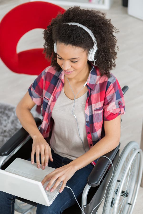 Disabled Lady Using Notepad Computer and Wearing Headphones Stock Image ...
