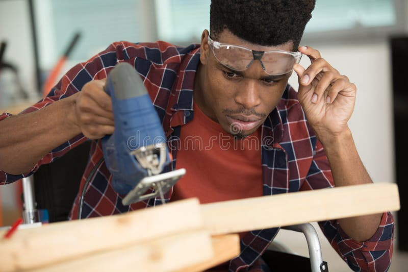 Disabled Male Carpenter Cutting Wood with Electric Jigsaw Stock Image ...