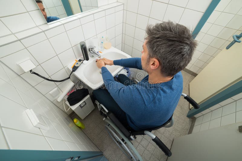 Disabled Man in Bathroom Washing Hands Stock Photo - Image of chair ...