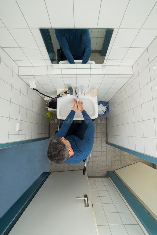Disabled Man in Bathroom Washing Hands Stock Photo - Image of chair ...