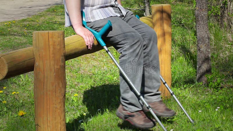 Disabled Man with Crutches Sitting and Moving Their Legs Stock Footage ...