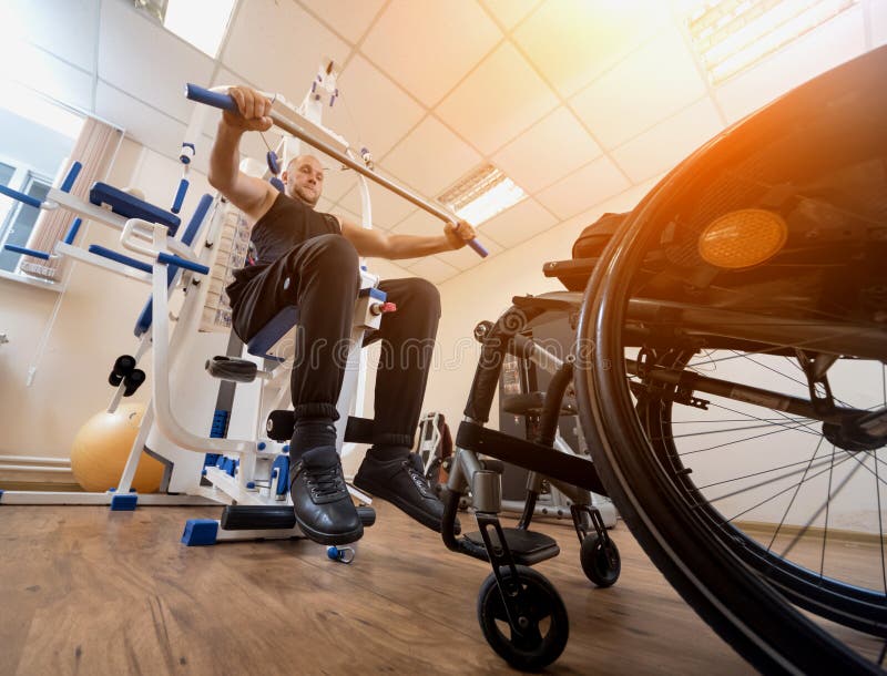 Disabled Man Doing Strength Exercises Separate from the Wheelchair ...