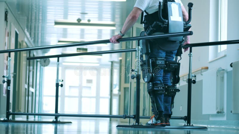 Disabled Man is Learning To Walk in the Exoskeleton Stock Footage ...