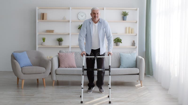 Disabled Man Making Step with Disability Walking Frame at Home Stock ...
