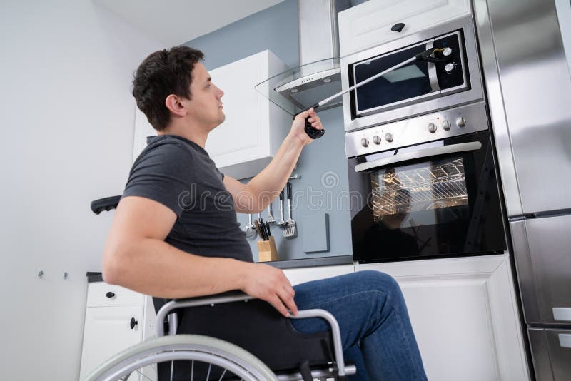 Disabled Man Using Grabber Tool in Kitchen Stock Photo - Image of ...
