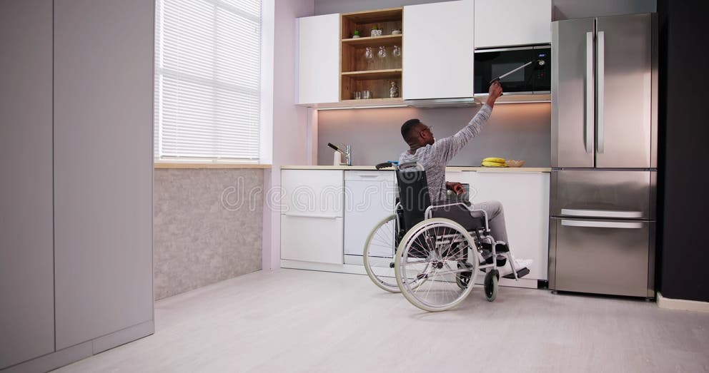 Disabled Man Using Grabber Tool To Control Microwave Stock Image ...