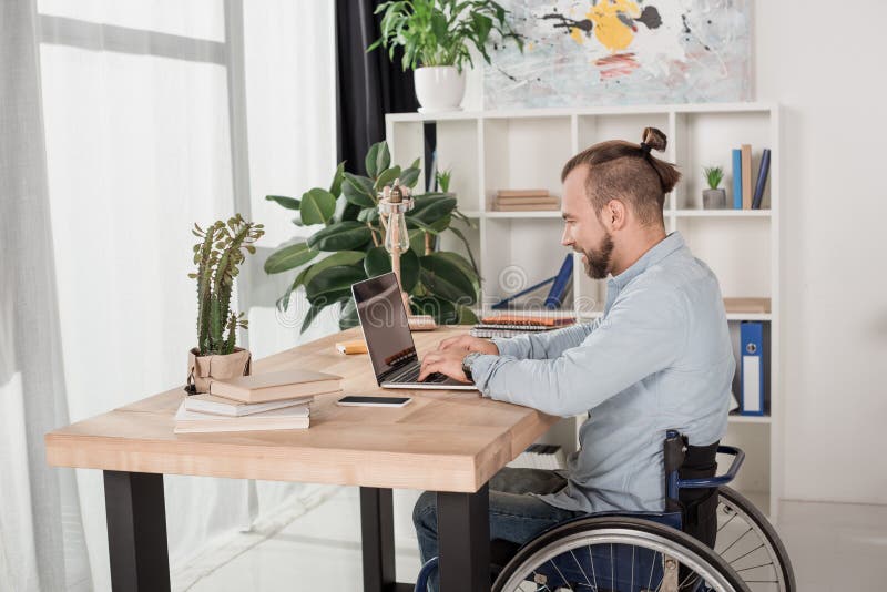 Disabled man using laptop stock image. Image of businessman - 104992687
