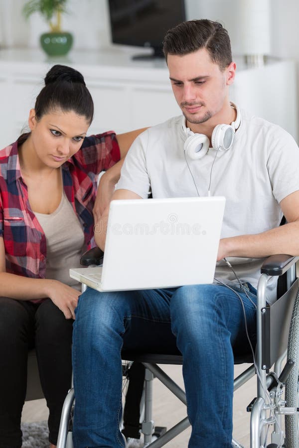 Disabled Man Using Laptop Sitting Next To Girlfriend Stock Photo ...