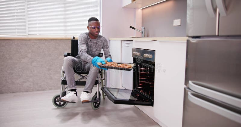 Disabled Man Using Microwave Oven for Baking Stock Photo - Image of ...
