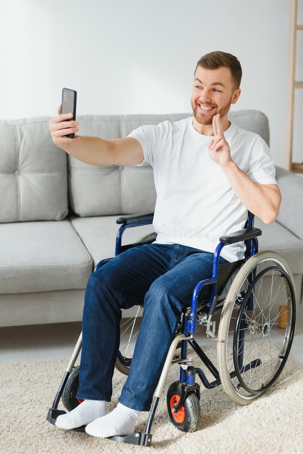 Disabled Man Using Modern Smartphone for Video Conversation while ...