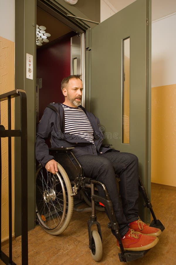 Disabled Man Living in City Apartment House Using Elevator Stock Photo ...