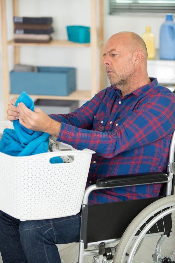 Disabled Man on Wheelchair Doing Laundry Stock Photo - Image of working ...