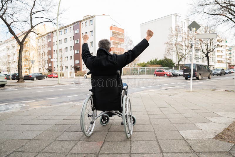 Disabled Man on Wheelchair with Hand Raised Stock Photo - Image of ...