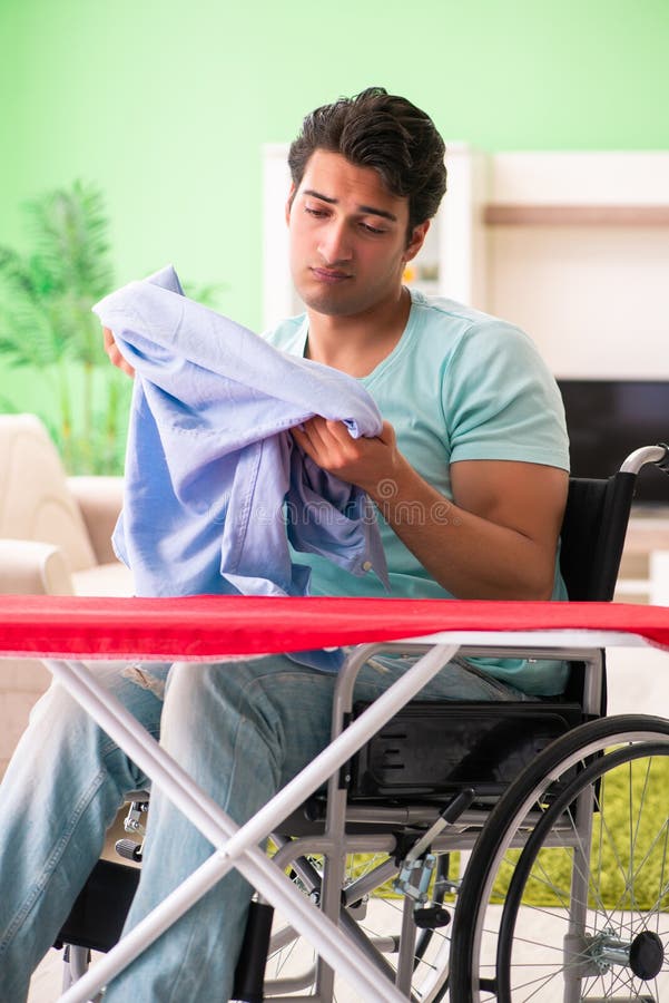 The Disabled Man on Wheelchair Ironing Clothing Stock Photo - Image of ...