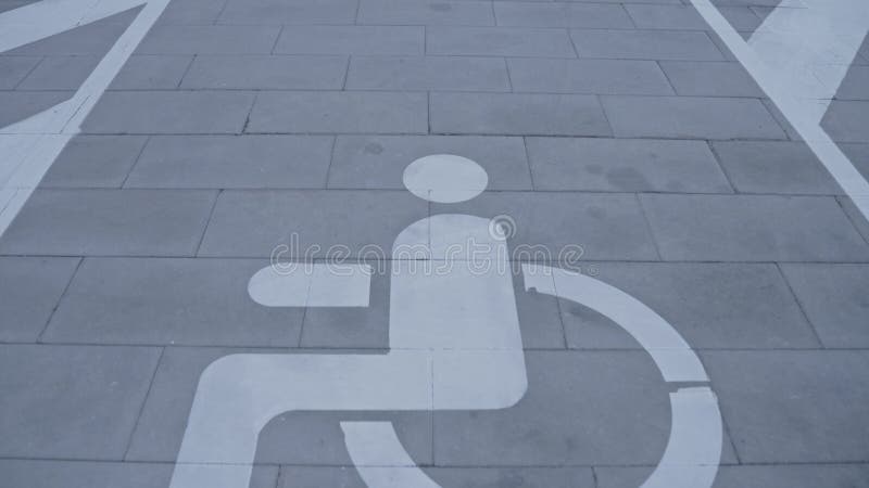 Disabled Parking Sign Rising from Asphalt Surface, Representing Urban ...