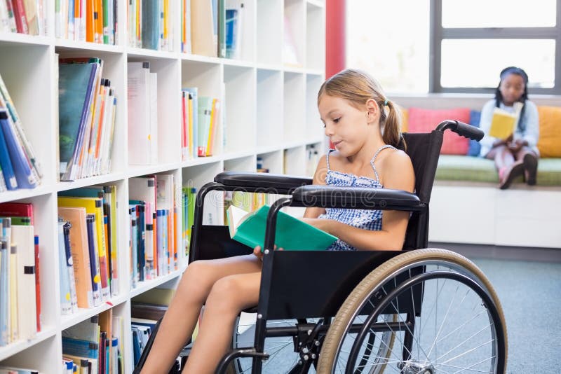 Disabled School Girl Selecting a Book from Bookshelf in Library Stock ... Disabled School Girl Selecting a Book from Bookshelf in Library Stock ...