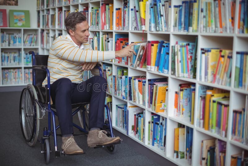 Disabled School Girl Selecting a Book from Bookshelf in Library Stock ... Disabled School Girl Selecting a Book from Bookshelf in Library Stock ...