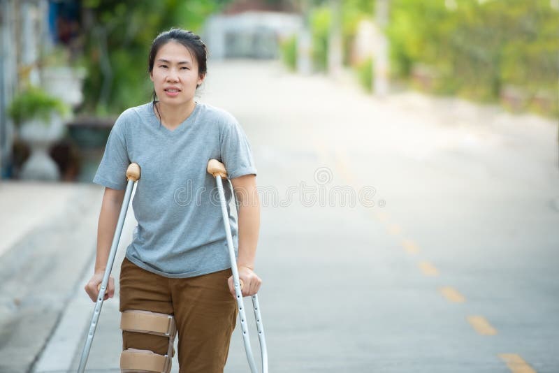Disabled Woman with Crutches or Walking Stick or Knee Support Standing ...